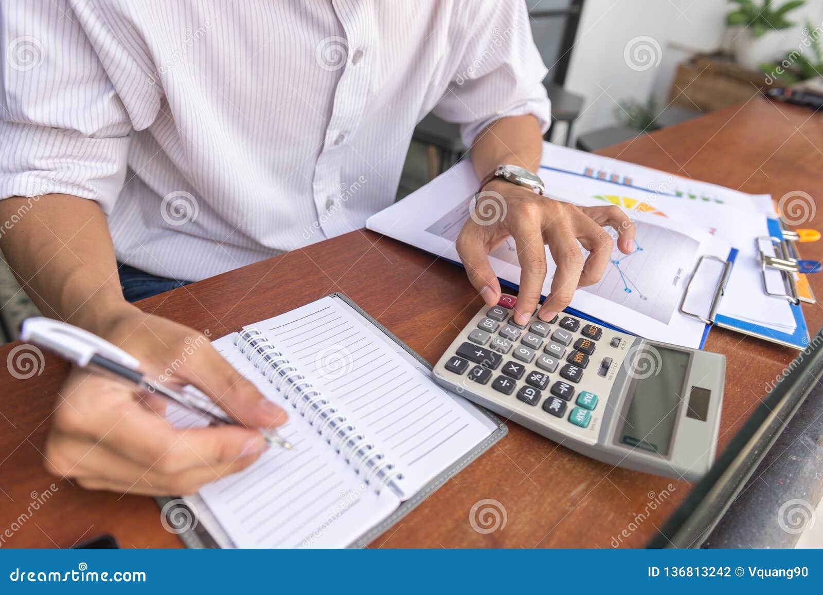 Close-up of Hands Using Calculator and Writing Note Stock Photo - Image ...