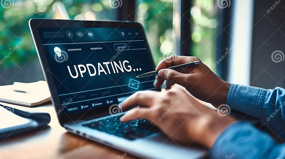 Close-up of Hands Using Laptop with "Updating..." Message on Screen ...