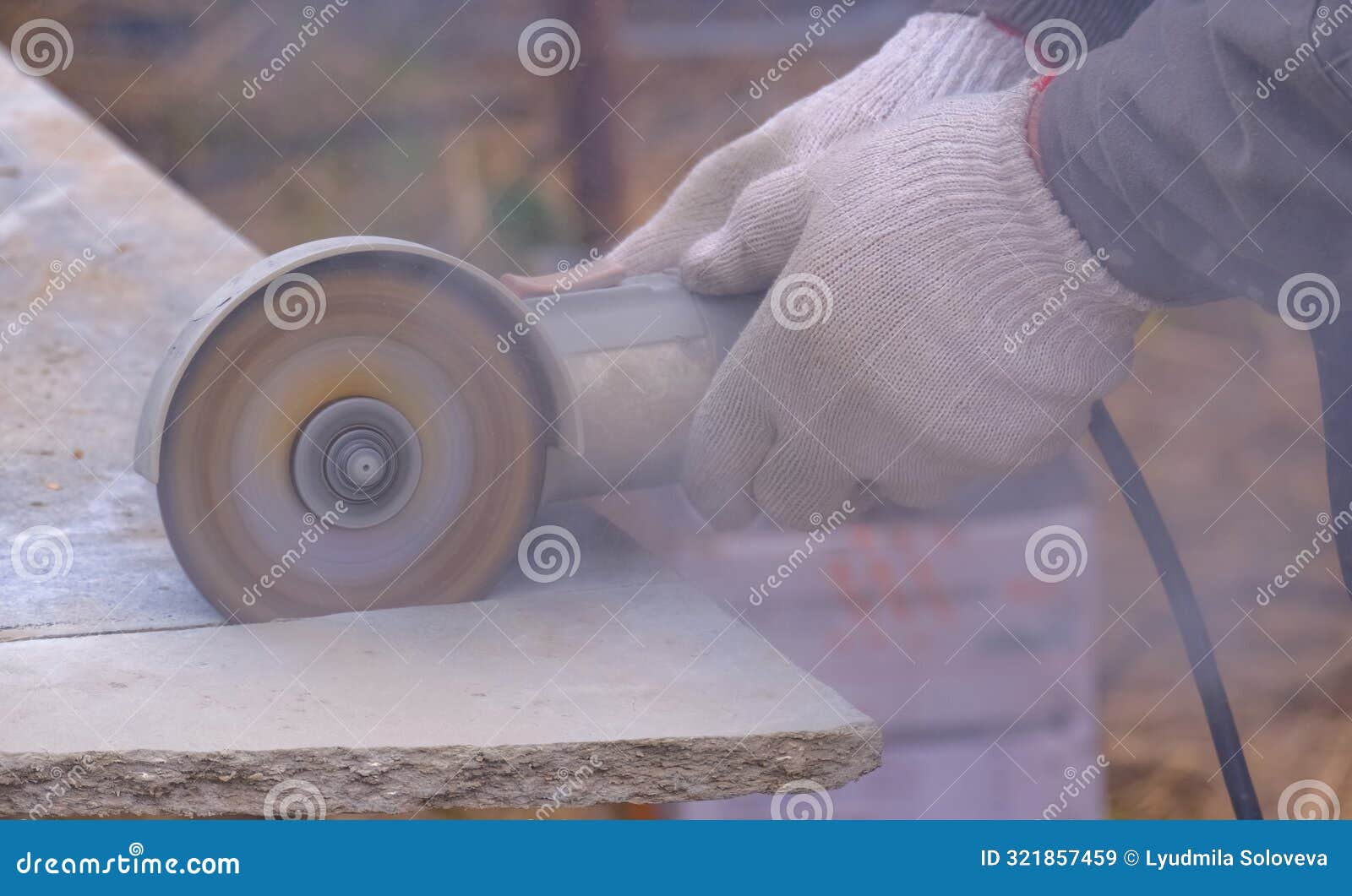 Close-up of the Hands of a Worker Sawing an Asbestos Slab on a Grinding ...