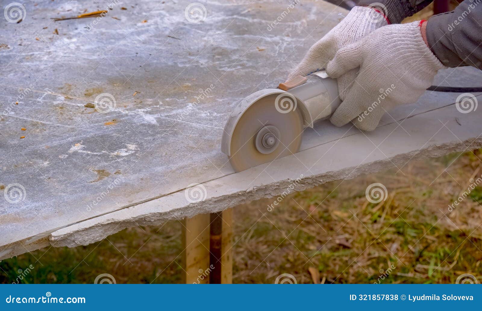 Close-up of the Hands of a Worker Sawing an Asbestos Slab on a Grinding ...