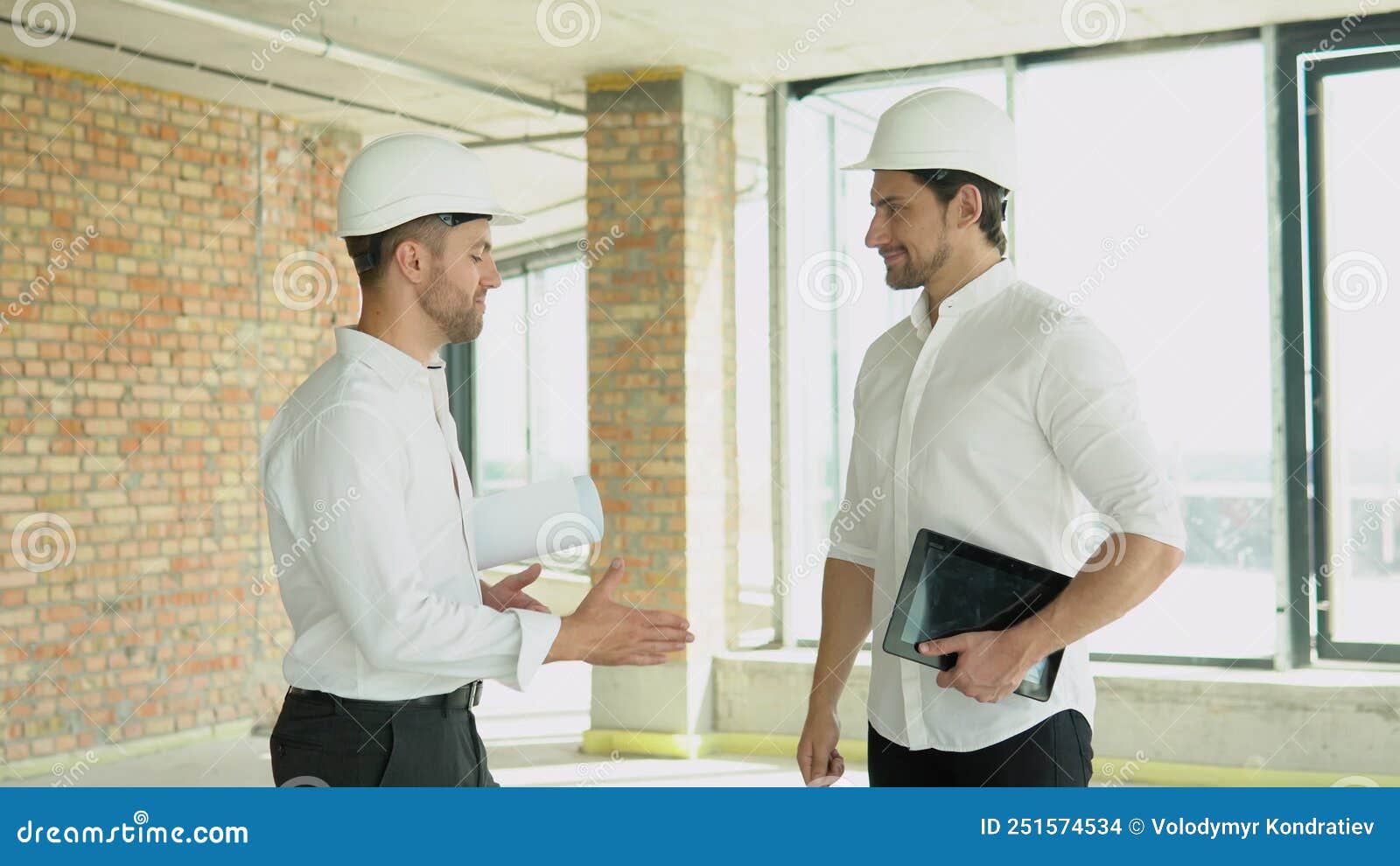 Friendly Handshake of Two Builders at a Construction Site. Close Up of ...