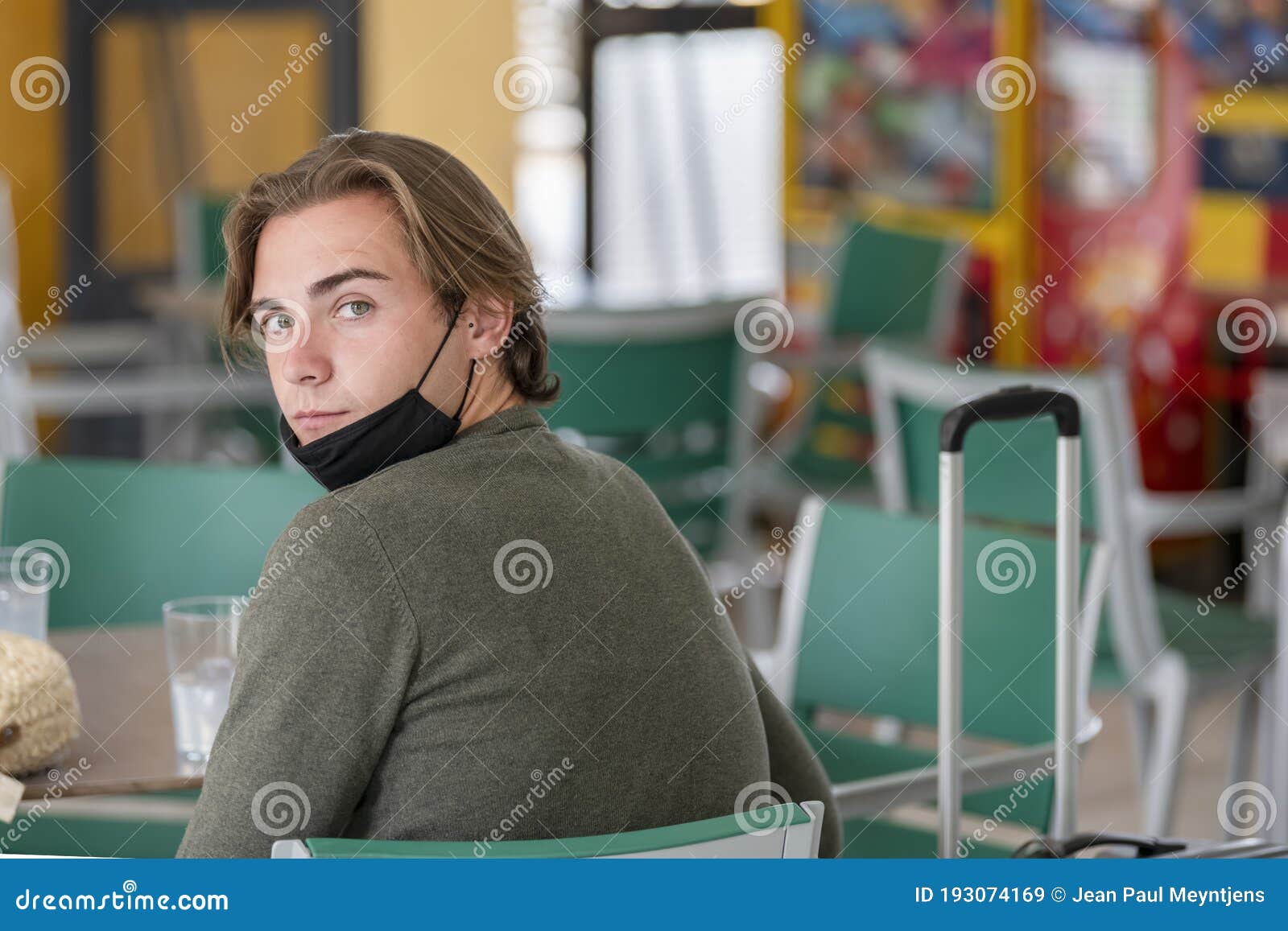 Close Up of a Handsome Young Man with His Face Mask Pulled Down Looking ...