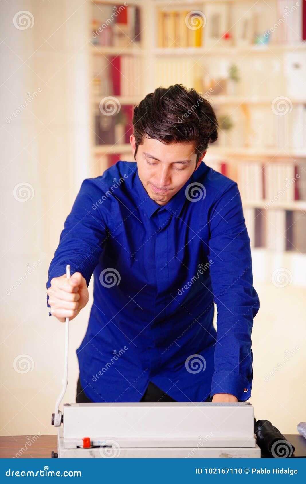 Close Up of Handsome Young Man Wearing a Blue T-shirt Using a Lever for ...