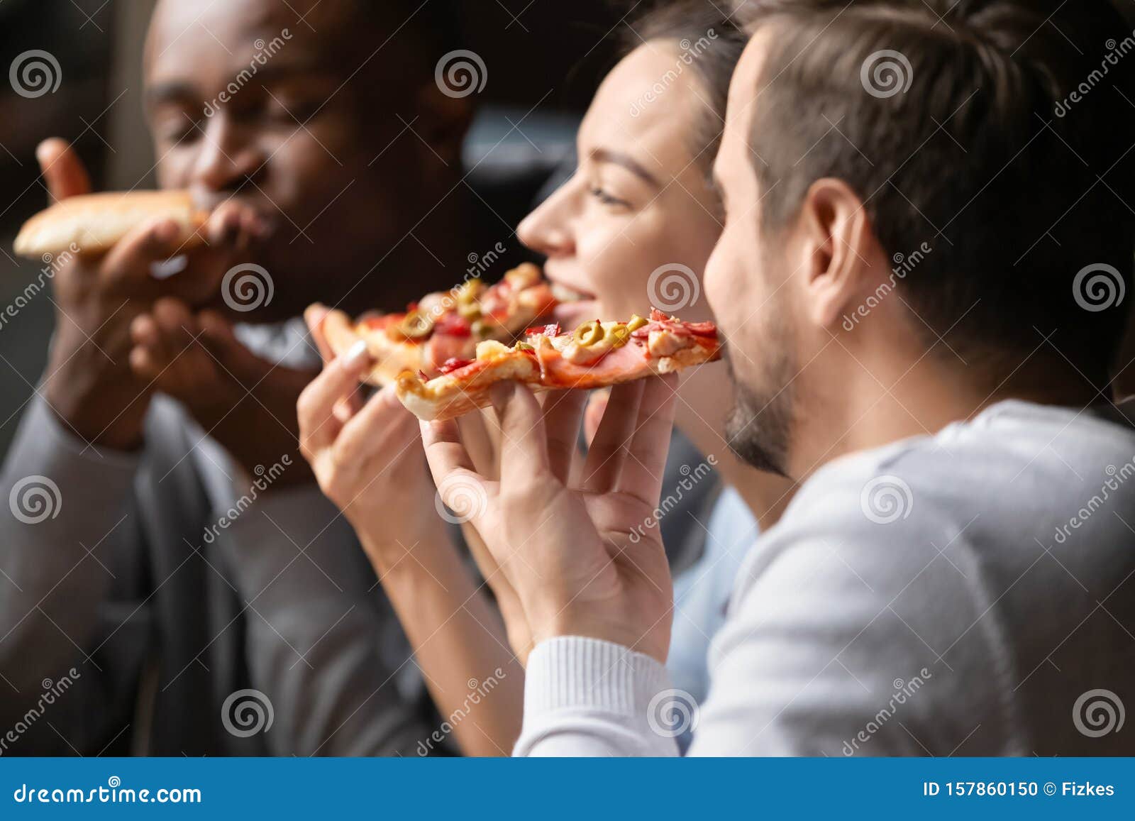 Close Up Happy Diverse Friends Eating Pizza In Cafe Together Stock