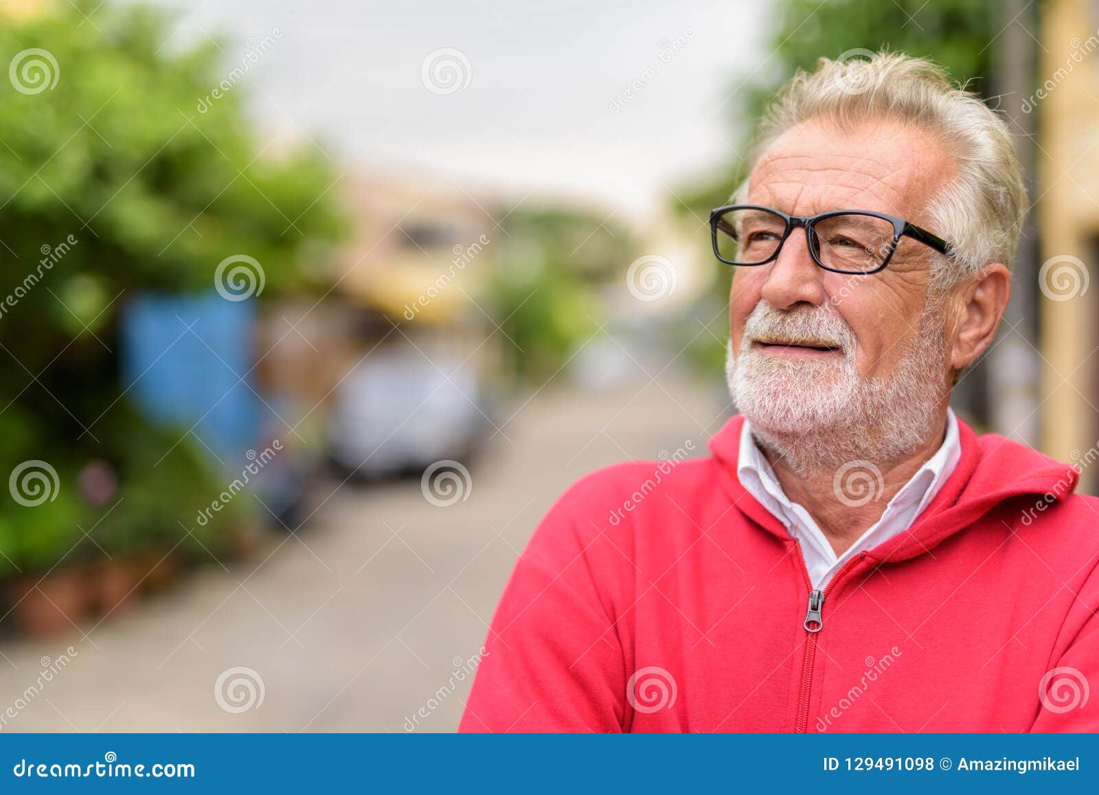 Close Up Of Happy Handsome Senior Bearded Man Smiling While Thin Stock