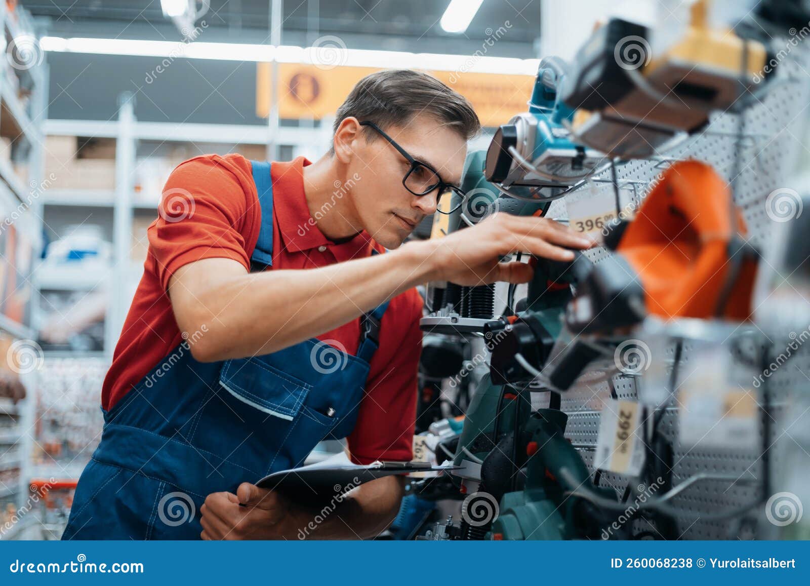 Hardware Store Supervisor Checking the Markings on Power Tools. Stock ...