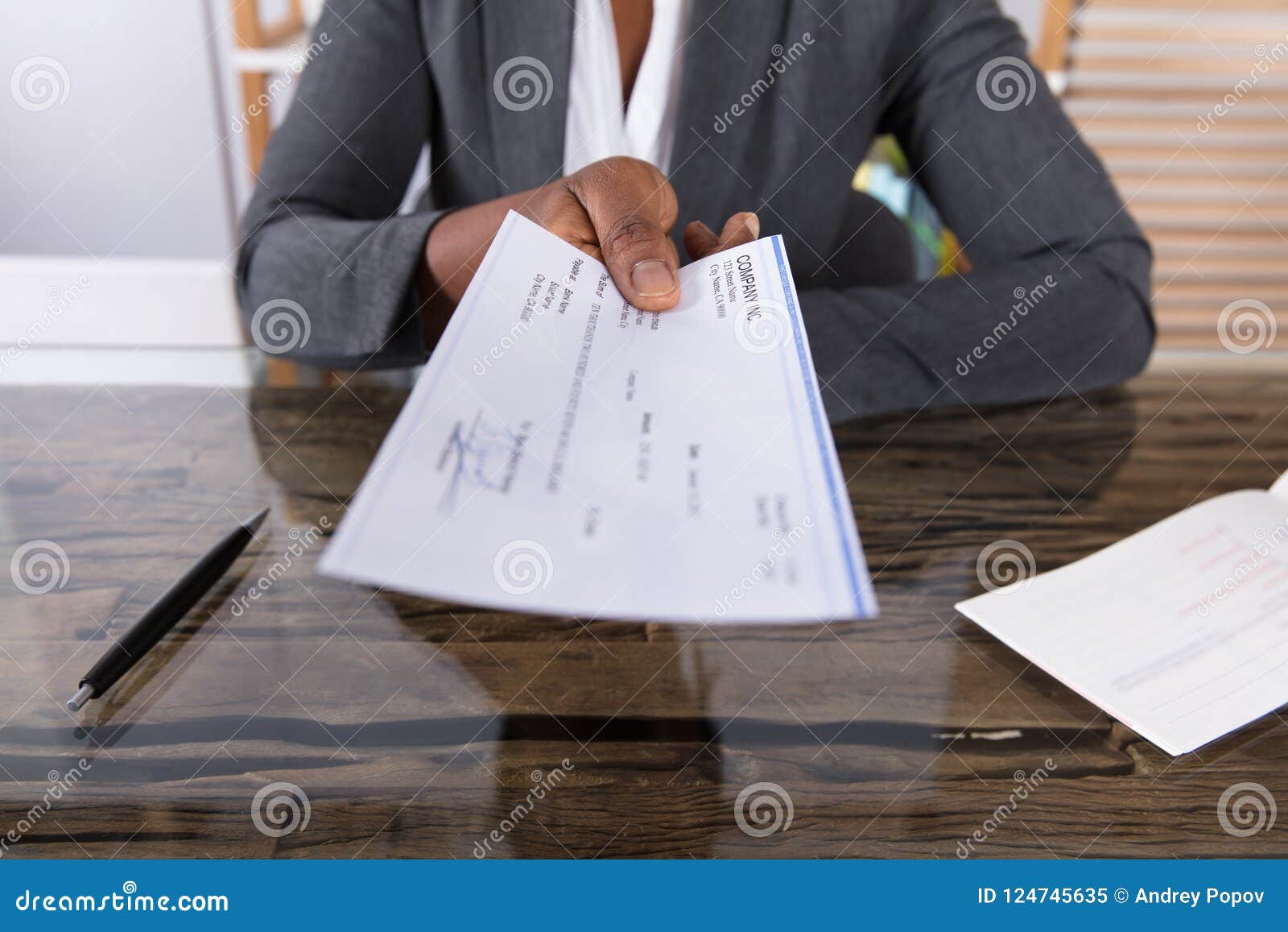 Human Hand Giving Cheque stock image. Image of investment - 124745635