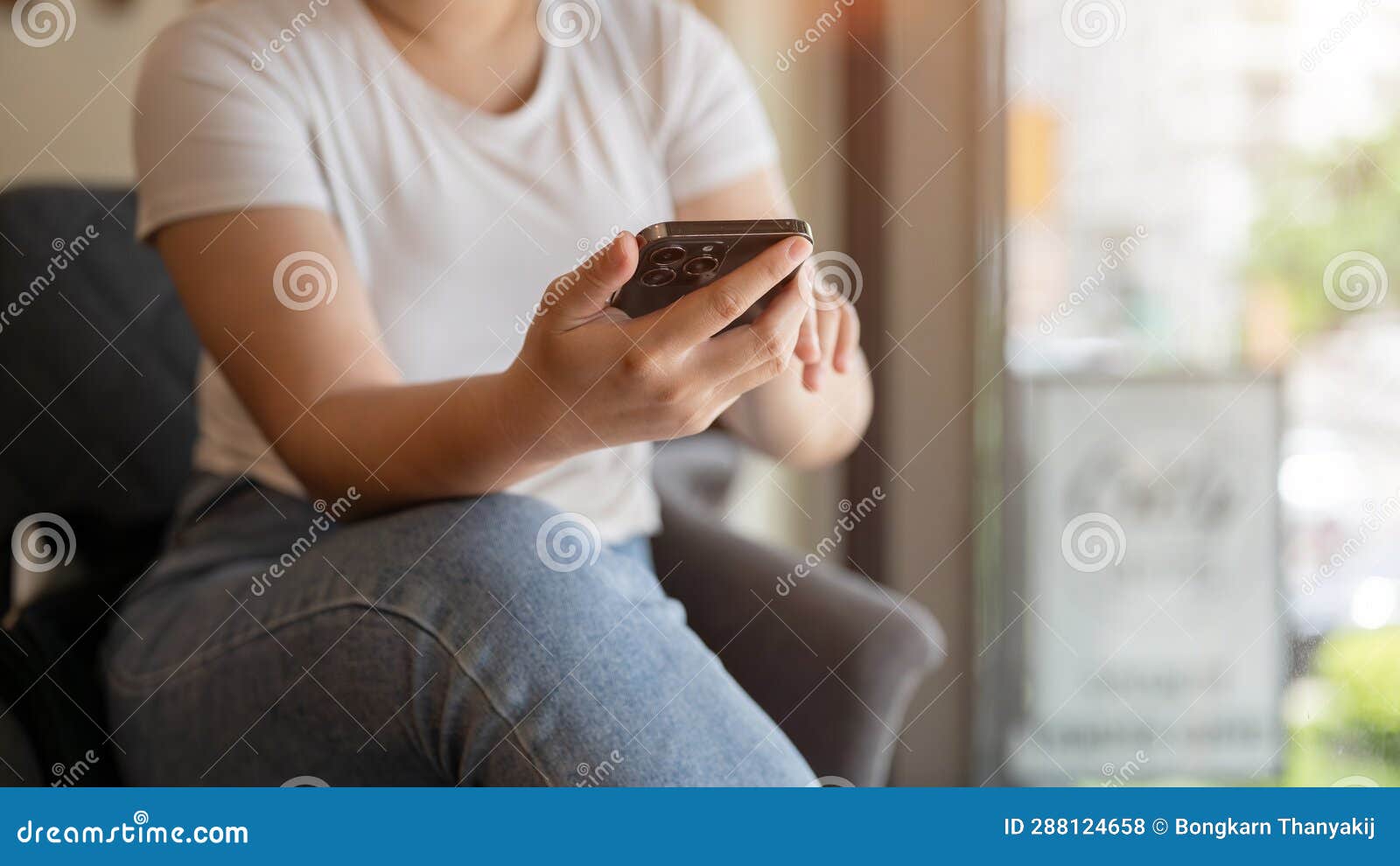 Close-up Image of a Female Using Her Smartphone while Sitting in a ...