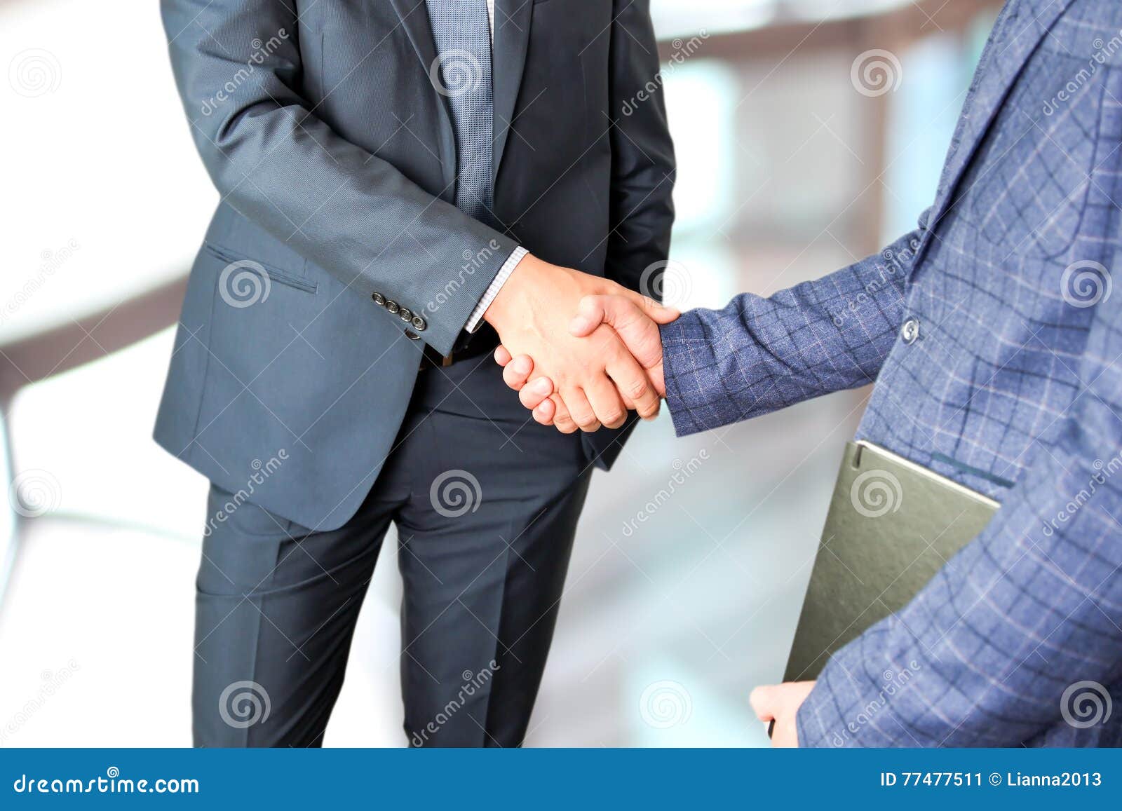 The Close-up Image of a Firm Handshake between Two Colleagues in Office ...