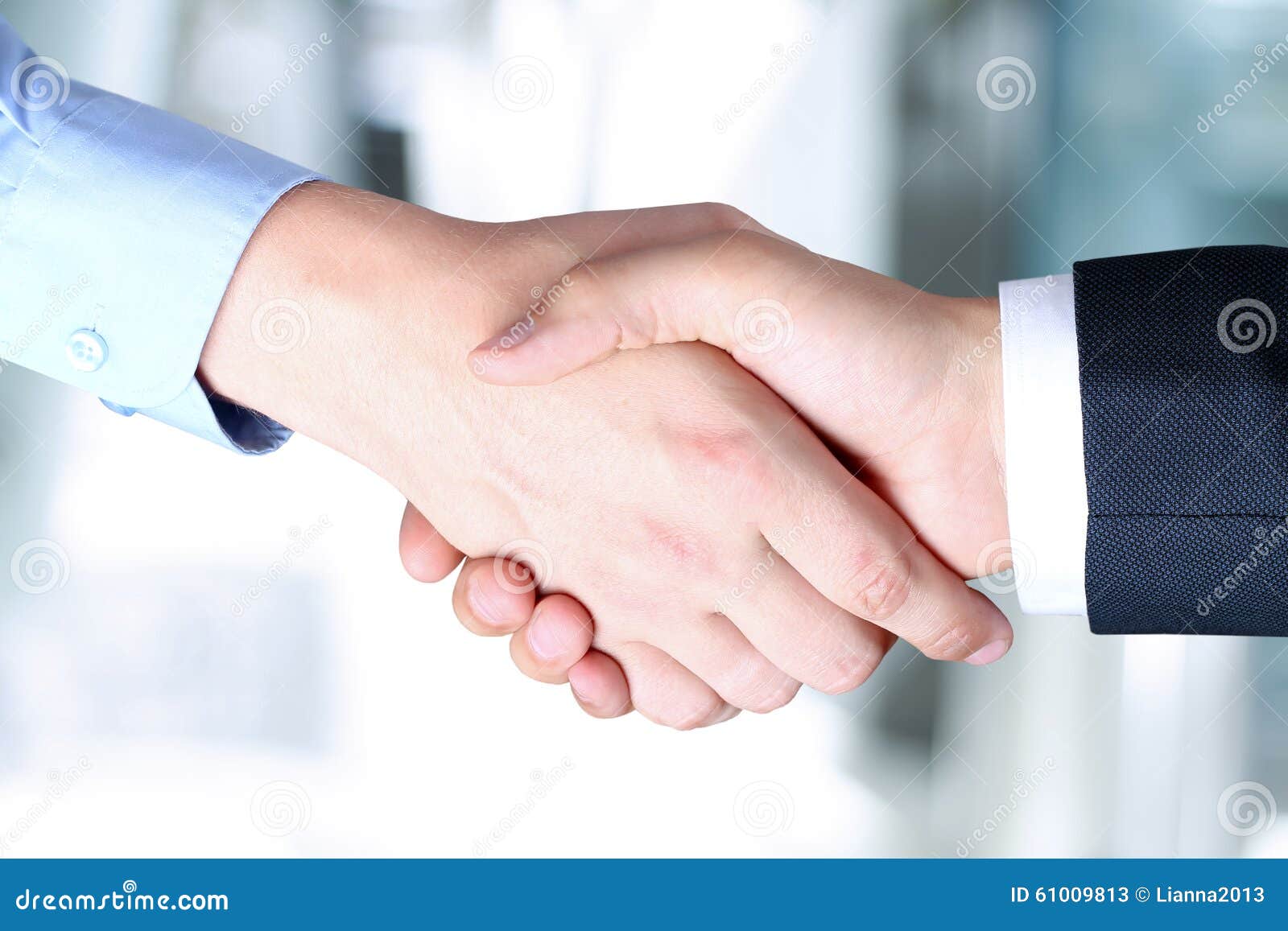 The Close-up Image of a Firm Handshake between Two Colleagues in Office ...