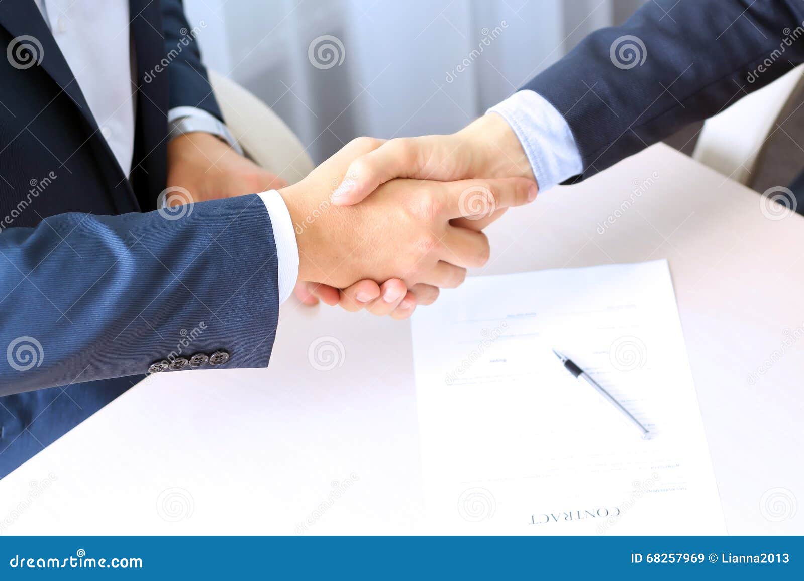 Close-up Image of a Firm Handshake between Two Colleagues after Signing ...