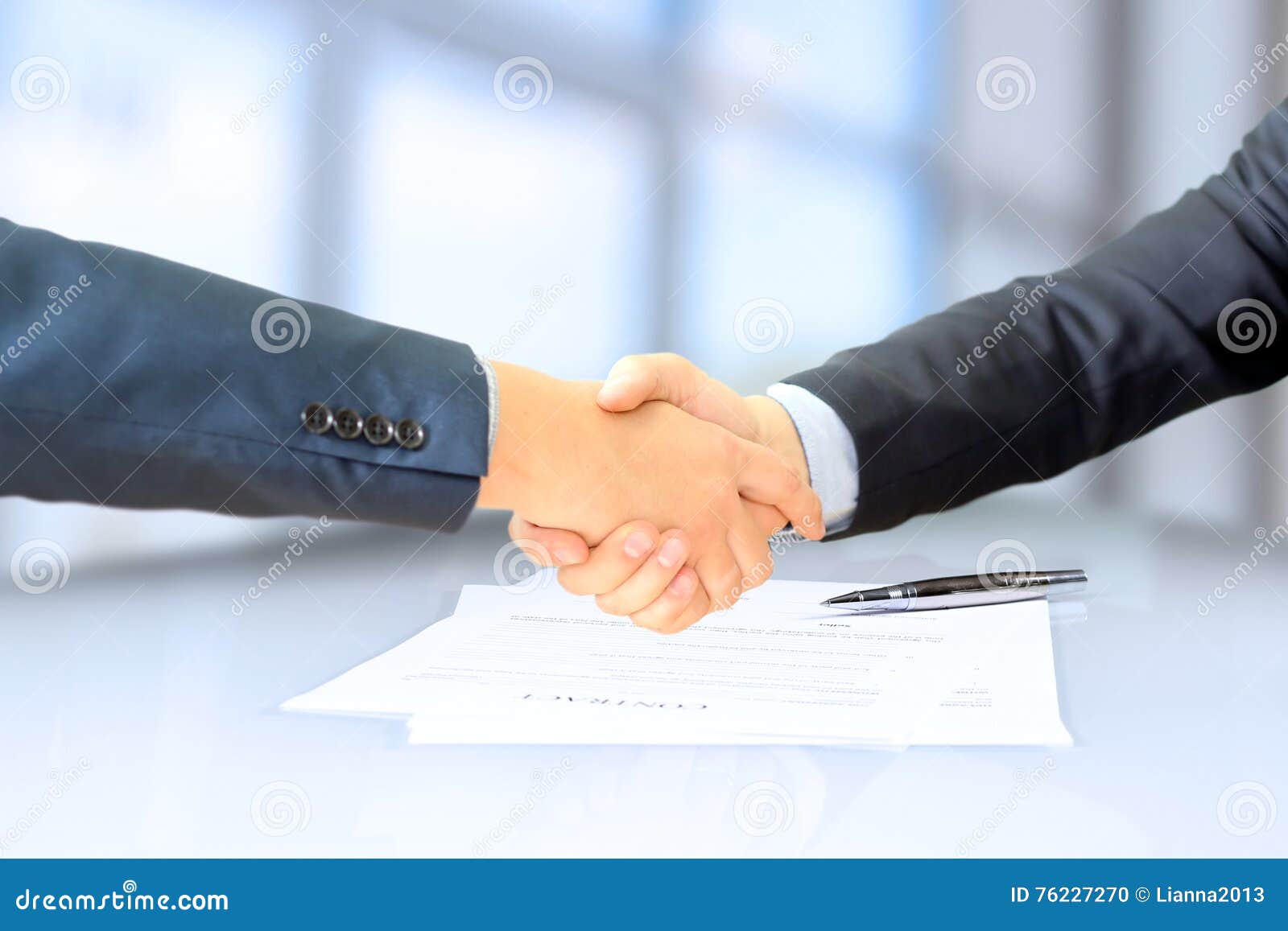 Close-up Image of a Firm Handshake between Two Colleagues after Signing ...