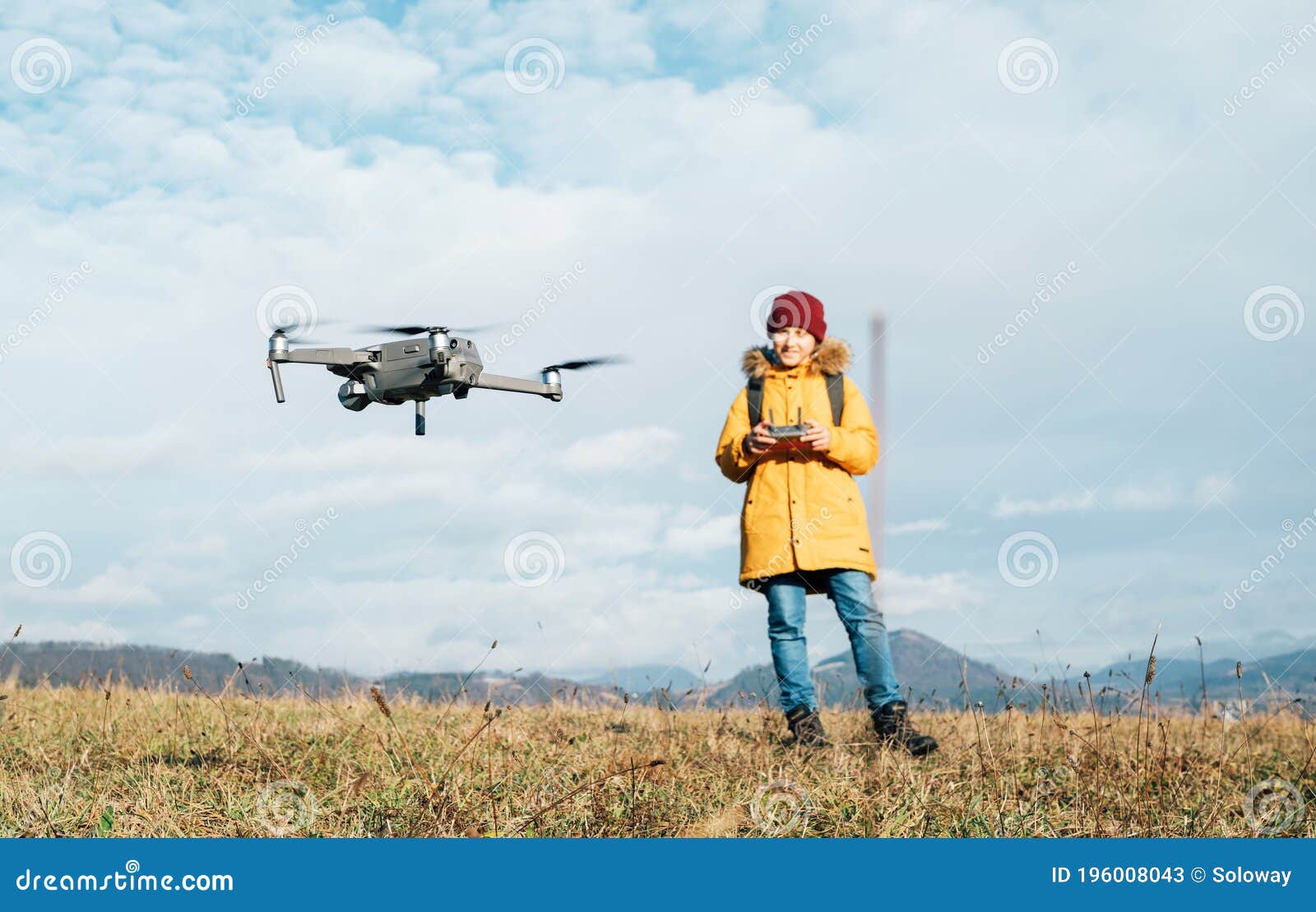 Close Up Image of Flying Drone with Teenager Boy Dressed Yellow Jacket ...
