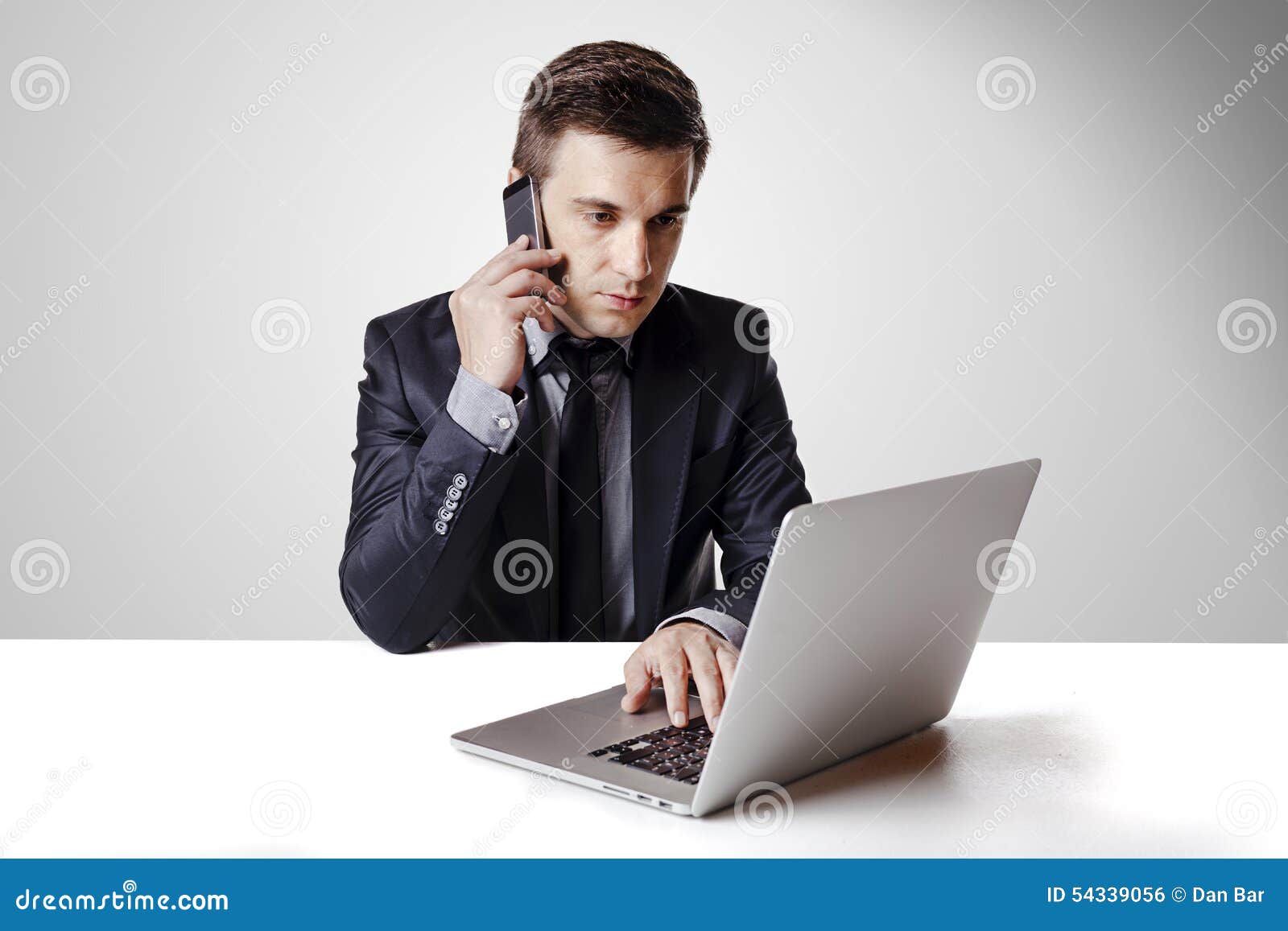 Close Up Image of Multitasking Business Man Using a Laptop and Mobile ...