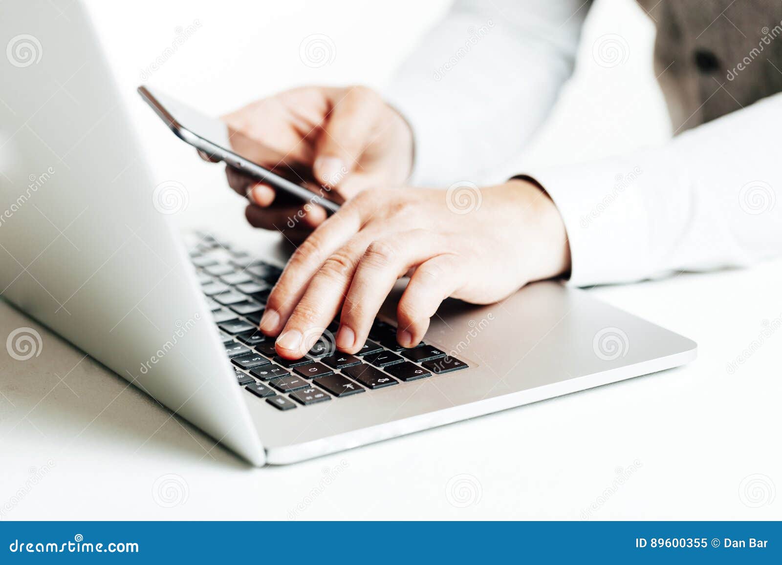 Close Up Image of Multitasking Business Man Using a Laptop and Mobile ... Close Up Image of Multitasking Business Man Using a Laptop and Mobile ...