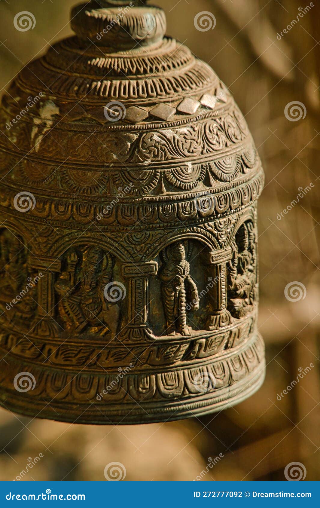 An Ornate Bell Hanging from the Ceiling in a Building with Other ...