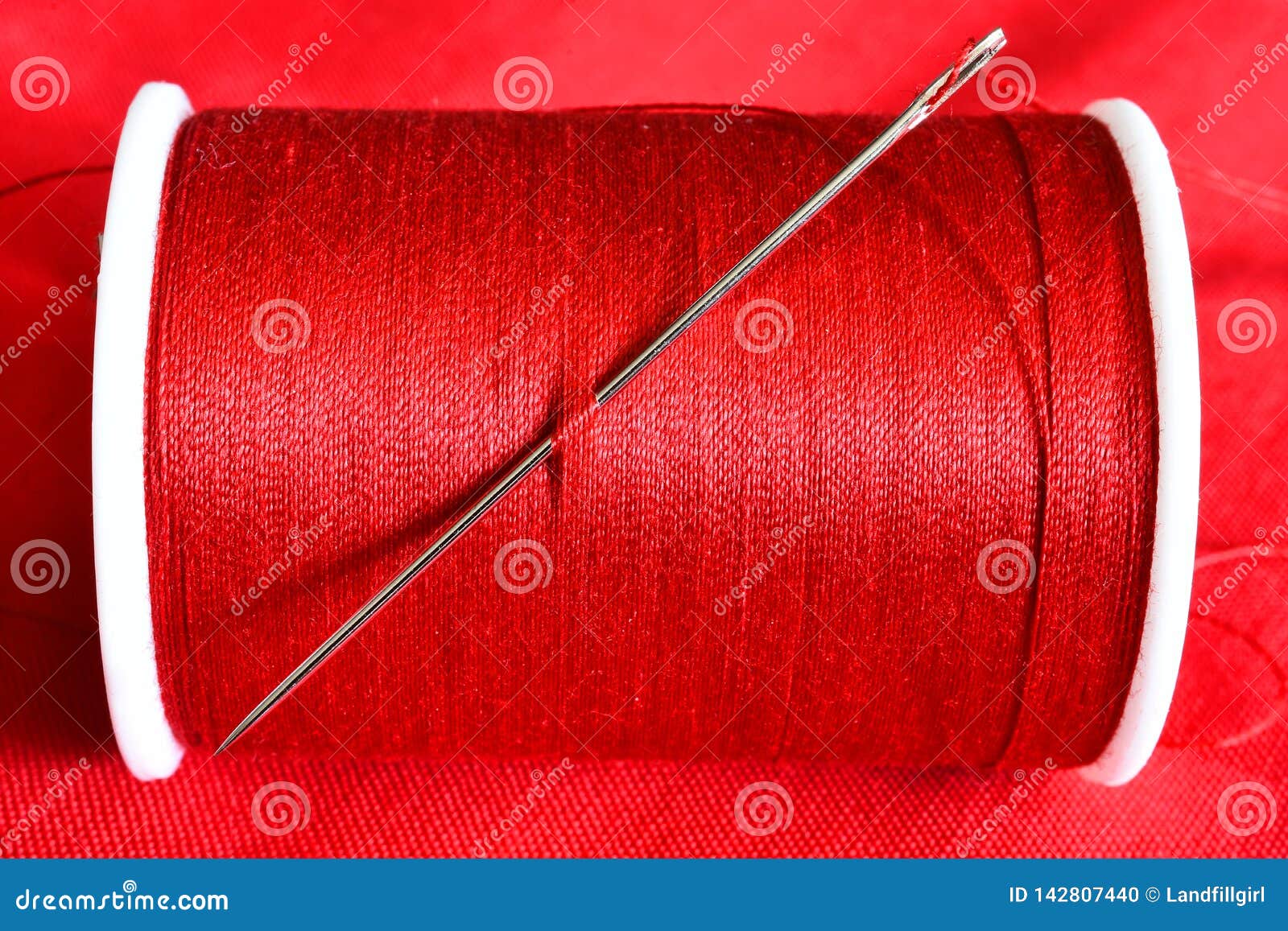 Red Thread and Sewing Needle Stock Photo - Image of spool, abstract ...