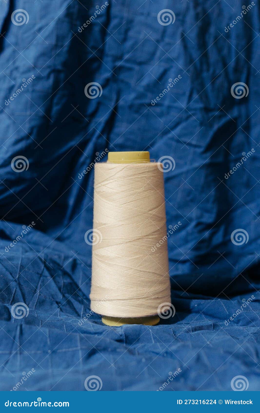 Close-up Image of a Spool of Thread on a Blue Background Stock Photo ...
