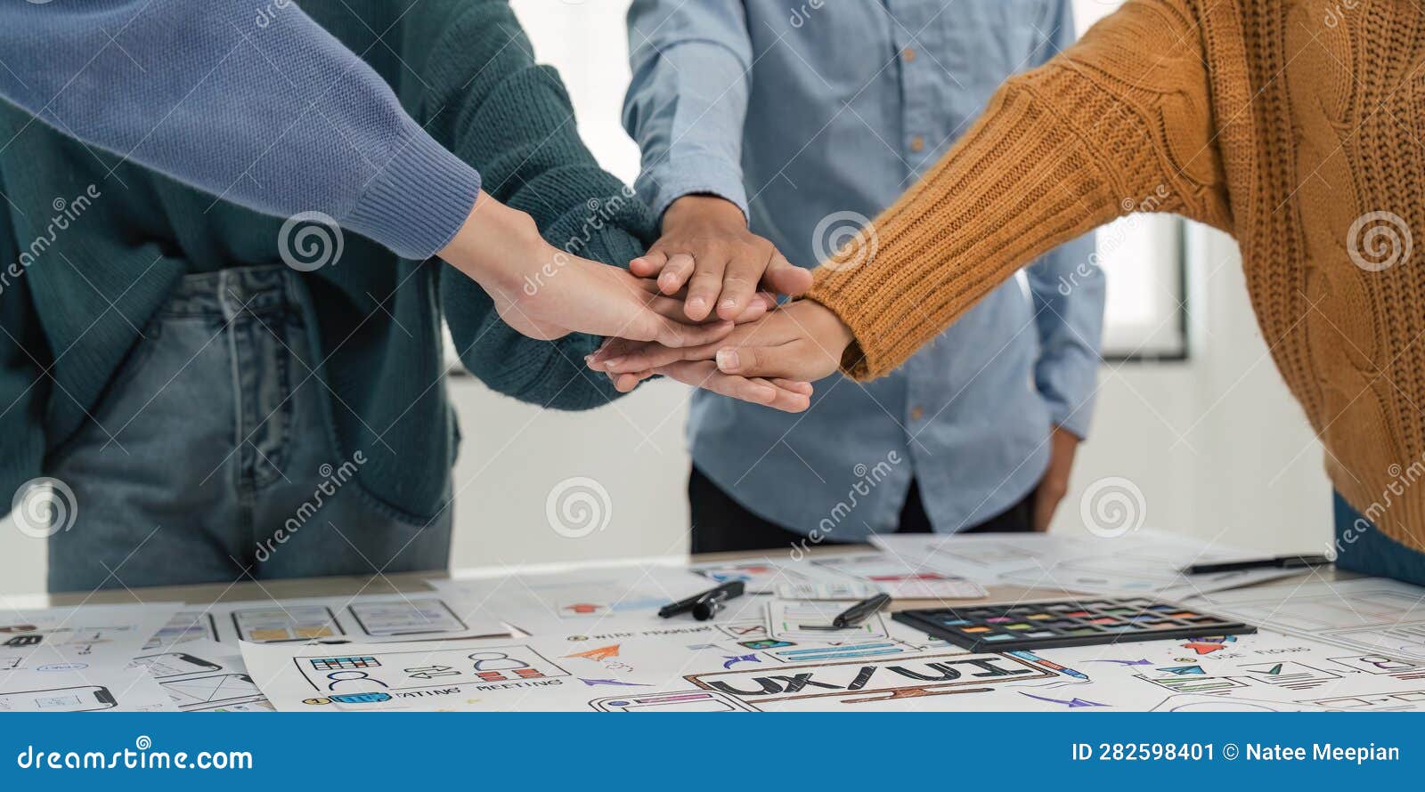 A Close-up Image of a Team of Developers or Graphic Designers Putting ...