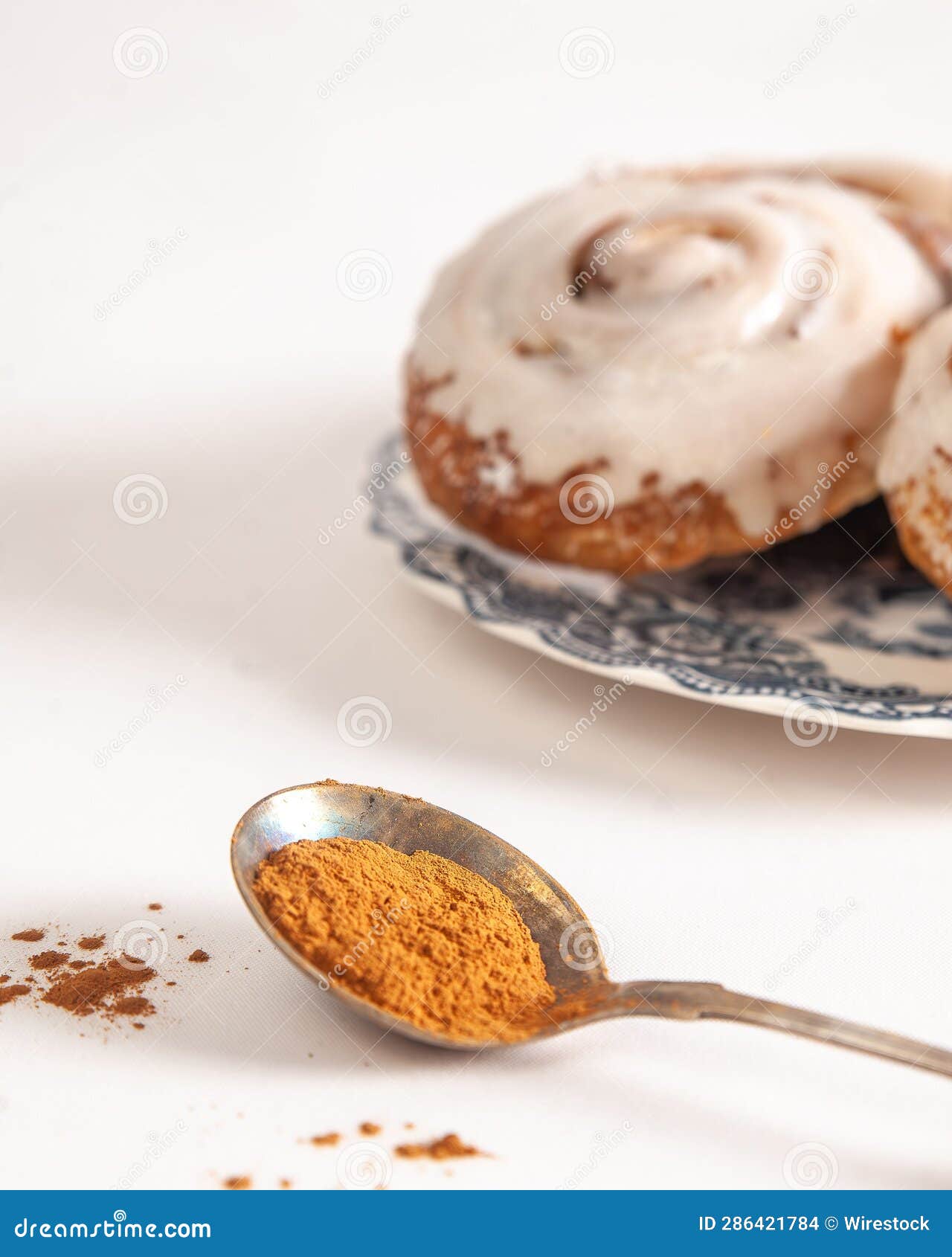 Close-up Image of Two Cinnabon Cinnamon Rolls on Plates, with a Spoon ...