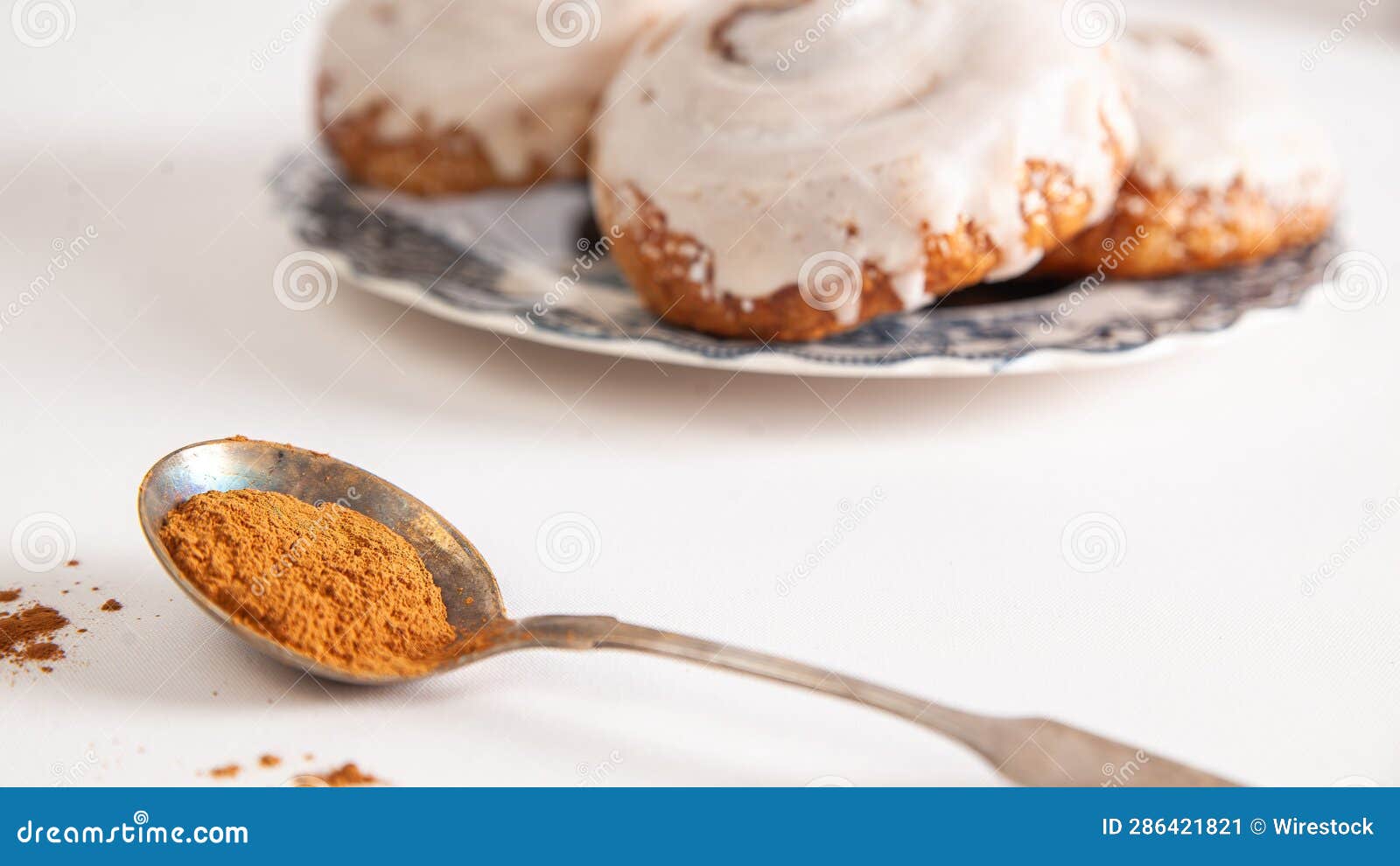 Close-up Image of Two Cinnabon Cinnamon Rolls on Plates, with a Spoon ...