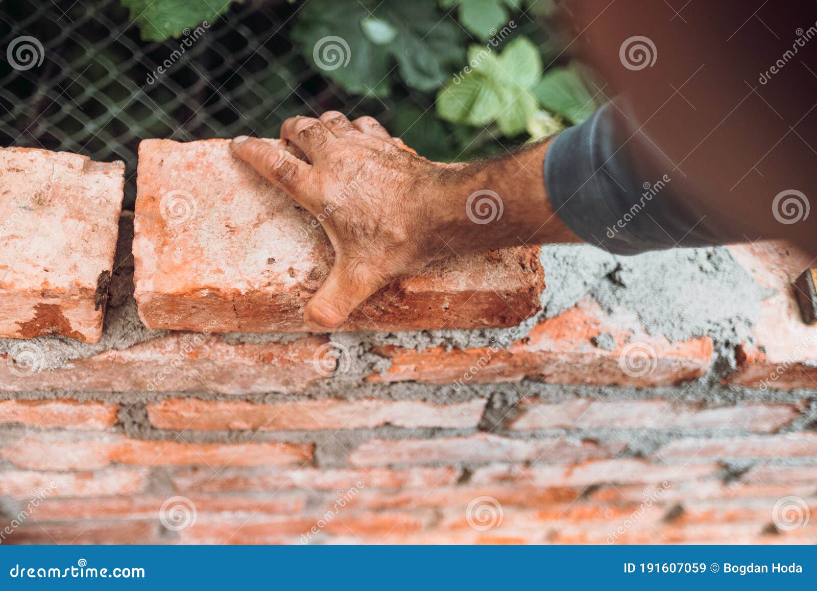 Close Up Of Bricklayer Builder Using Cement Mortar To Put The ...