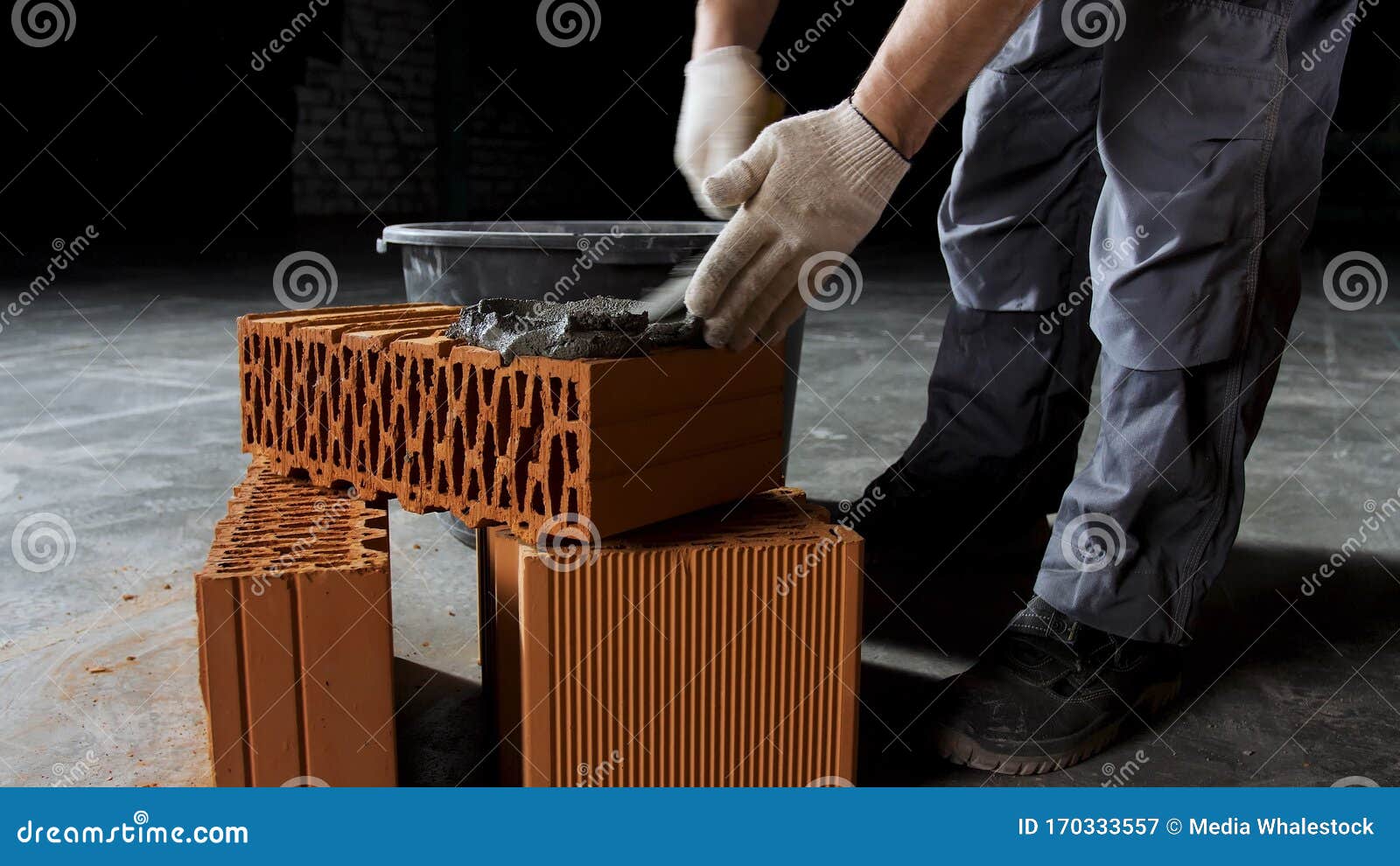 Close Up of an Industrial Worker Putting Cement on the Brick for ...