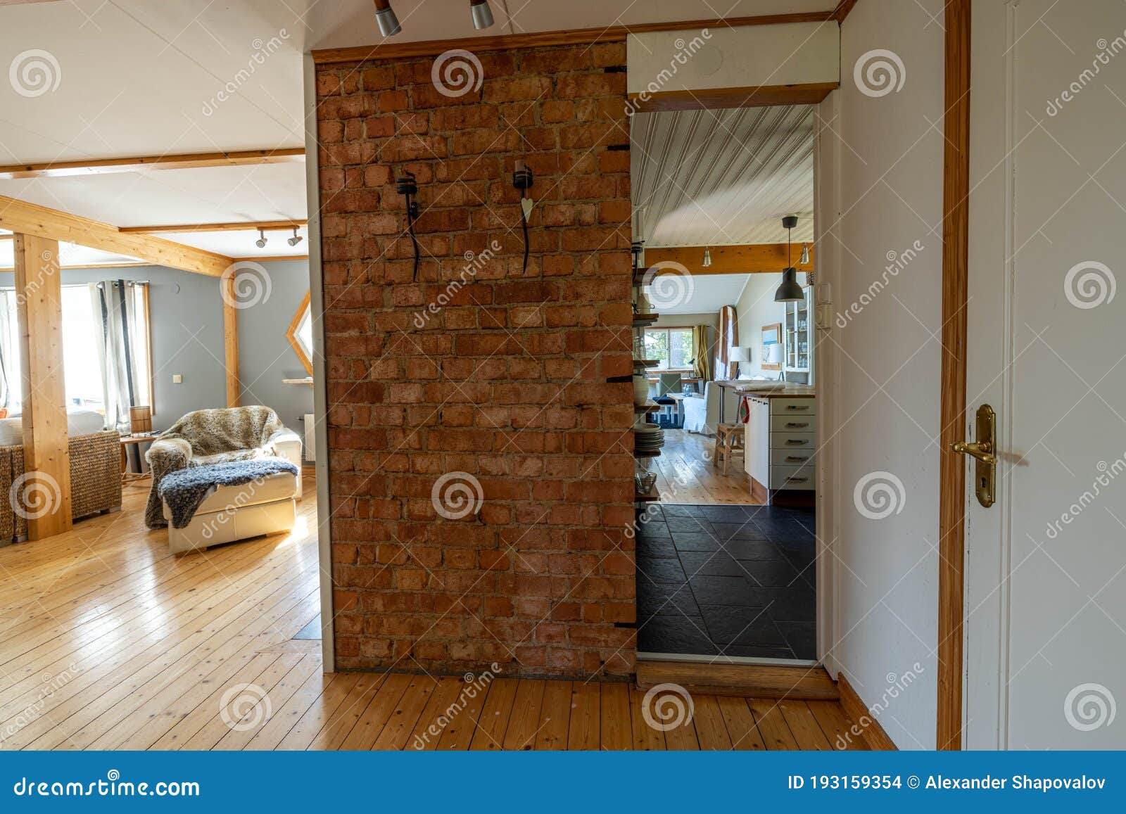 Close Up Interior View of Large Room with Brick Wall and Kitchen of a ...