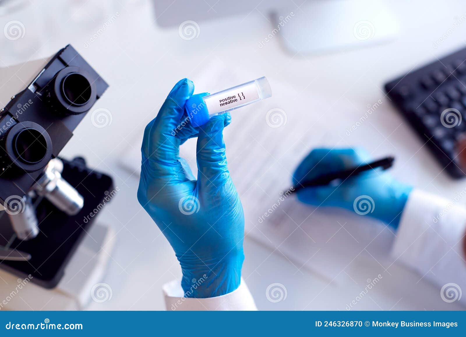 Close Up of Lab Worker Doing Test Using Microscope Holding Test Tube ...