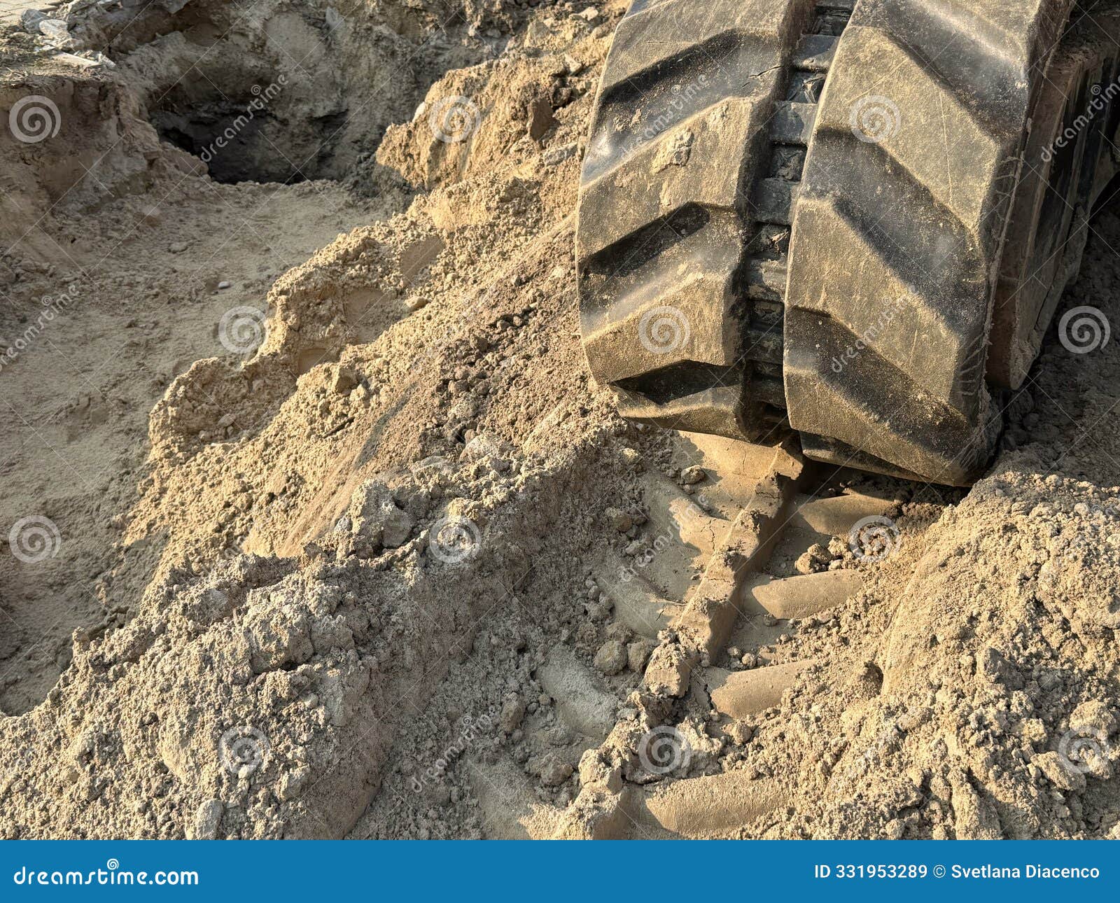 A Close-up of Large Excavator Tracks in the Dirt on a Construction Site ...