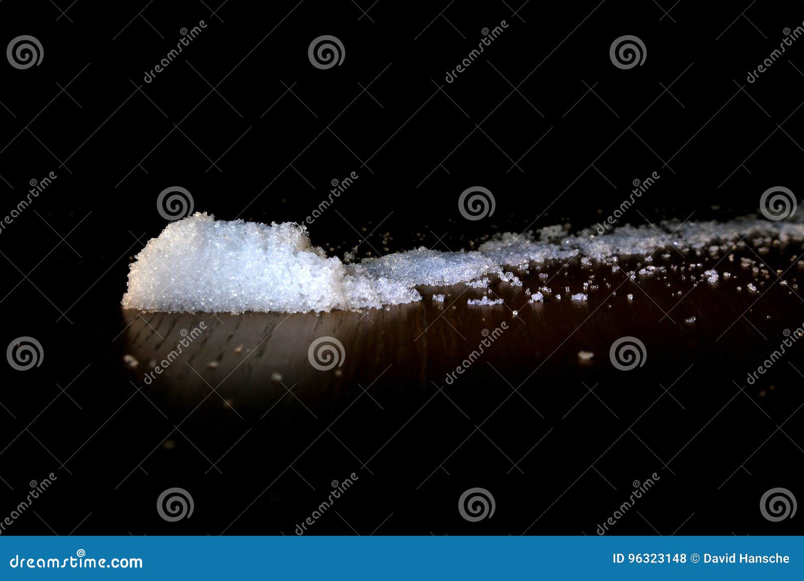 Close Up Larger Salt Pile Across a Dark Table - Alternate Lighting 2 ...