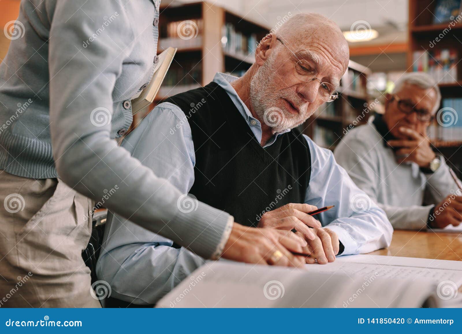 Close Up of a Lecturer Guiding an Elderly Student in Classroom Stock ...