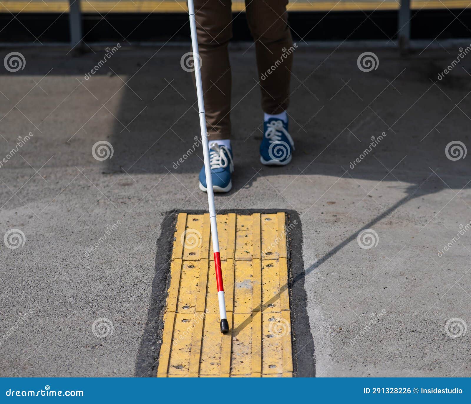 Close-up of the Legs of a Blind Woman at a Bus Stop. Stock Photo ...
