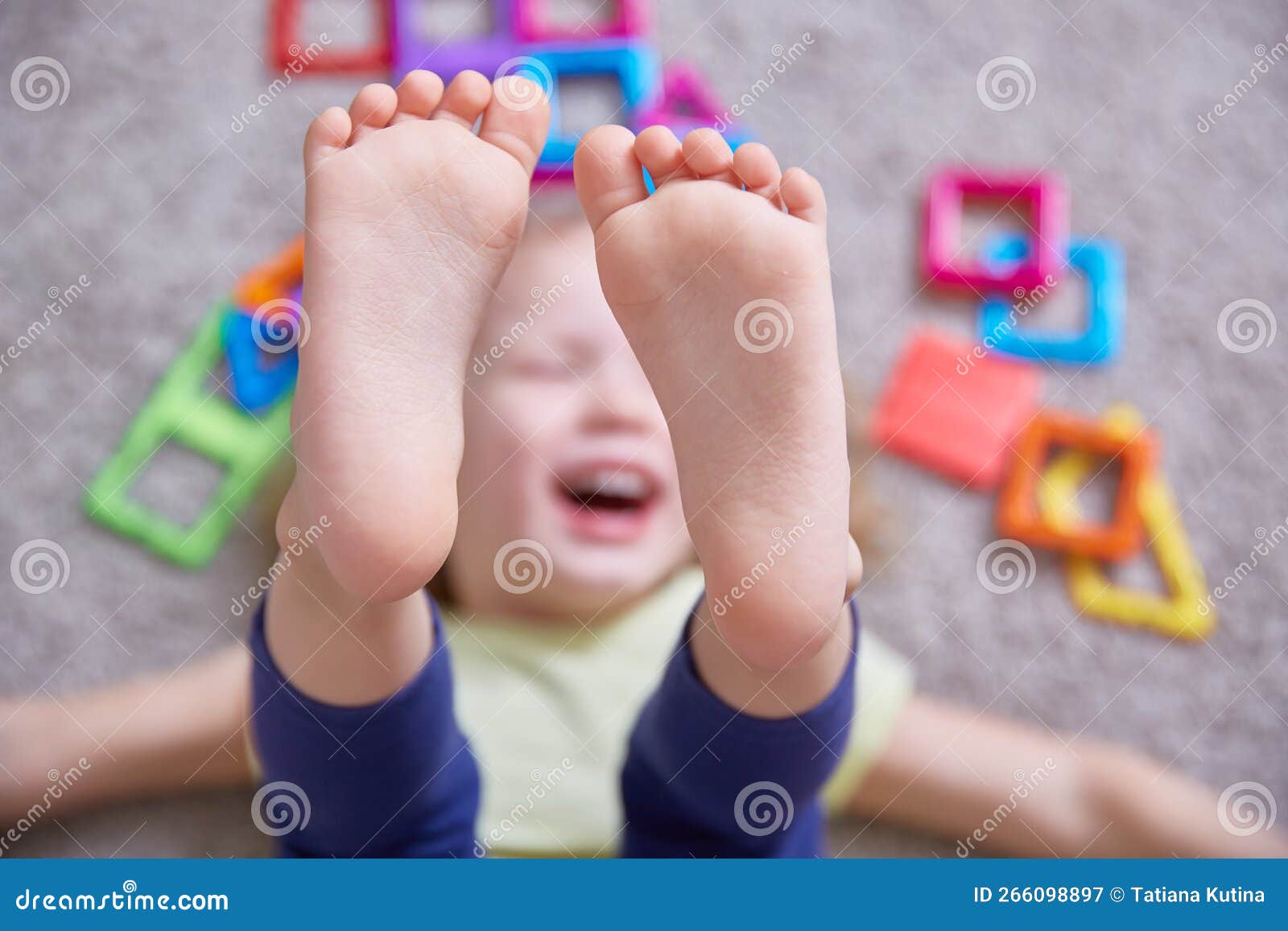 Close-up of the Legs of a Child Laughing on the Carpet Stock Image ...