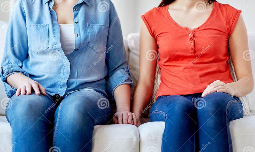 Close Up Of Lesbian Couple Sitting On Sofa At Home Stock Image Image