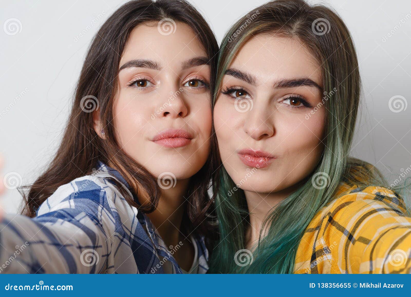 Close Up Lifestyle Selfie Portrait Of Two Young Positive Woman Having
