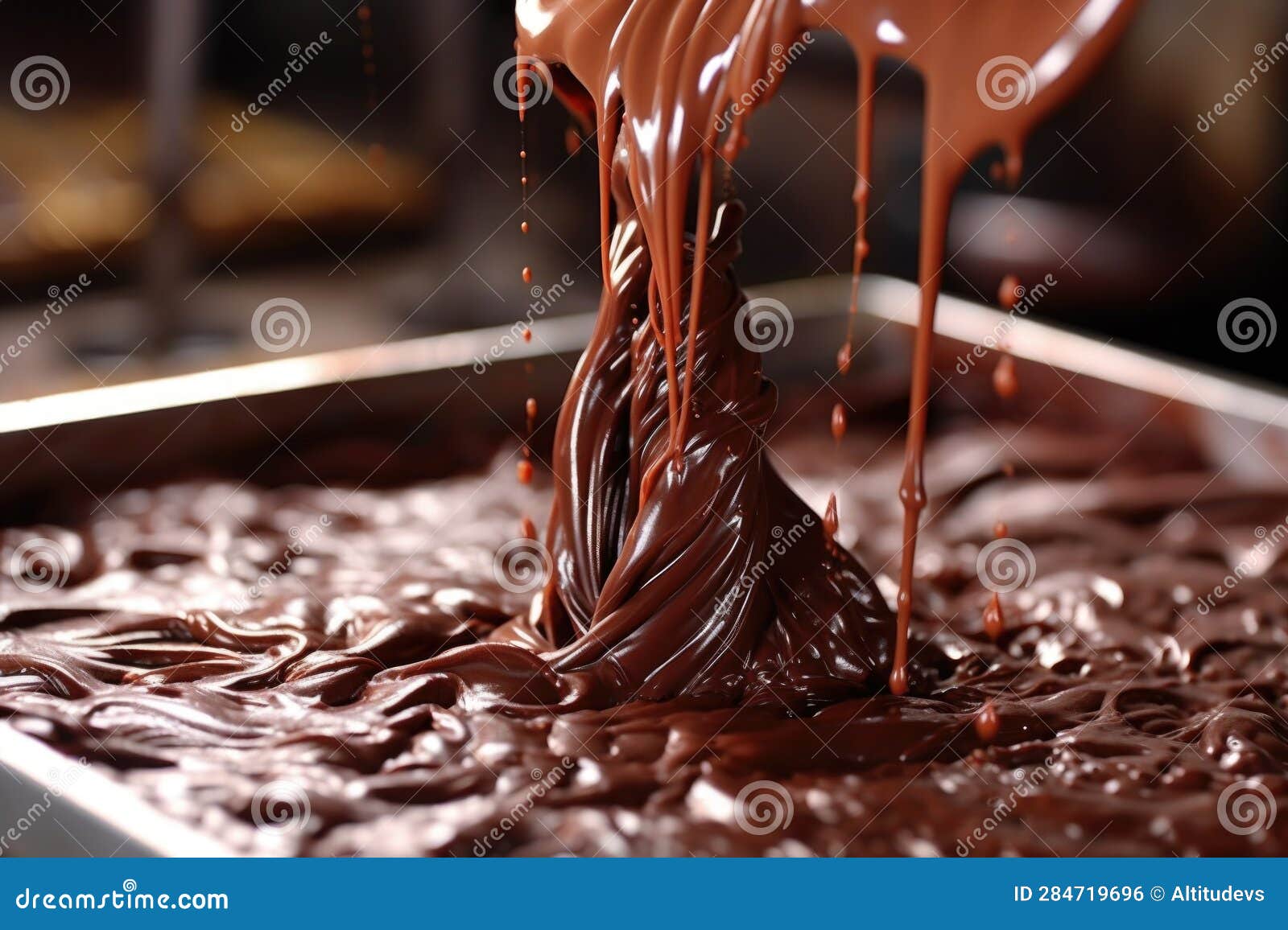 Close-up of Liquid Chocolate Being Poured into Molds Stock Photo ...