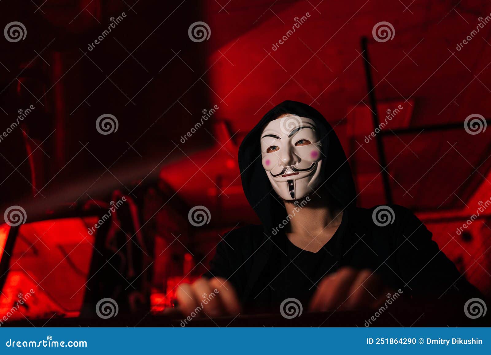 Close Up Low Angle View Of Dangerous Hacker Man Wearing Anonymous Mask And Sweatshirt Typing