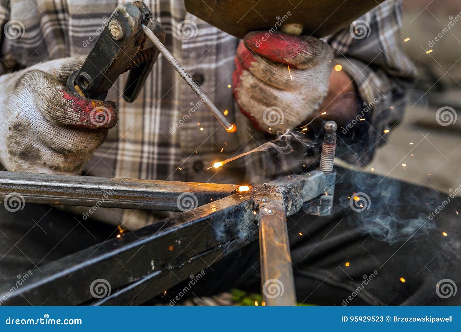 The Welder Using Electrode Welding The Steel Frame, Welding Sparks ...
