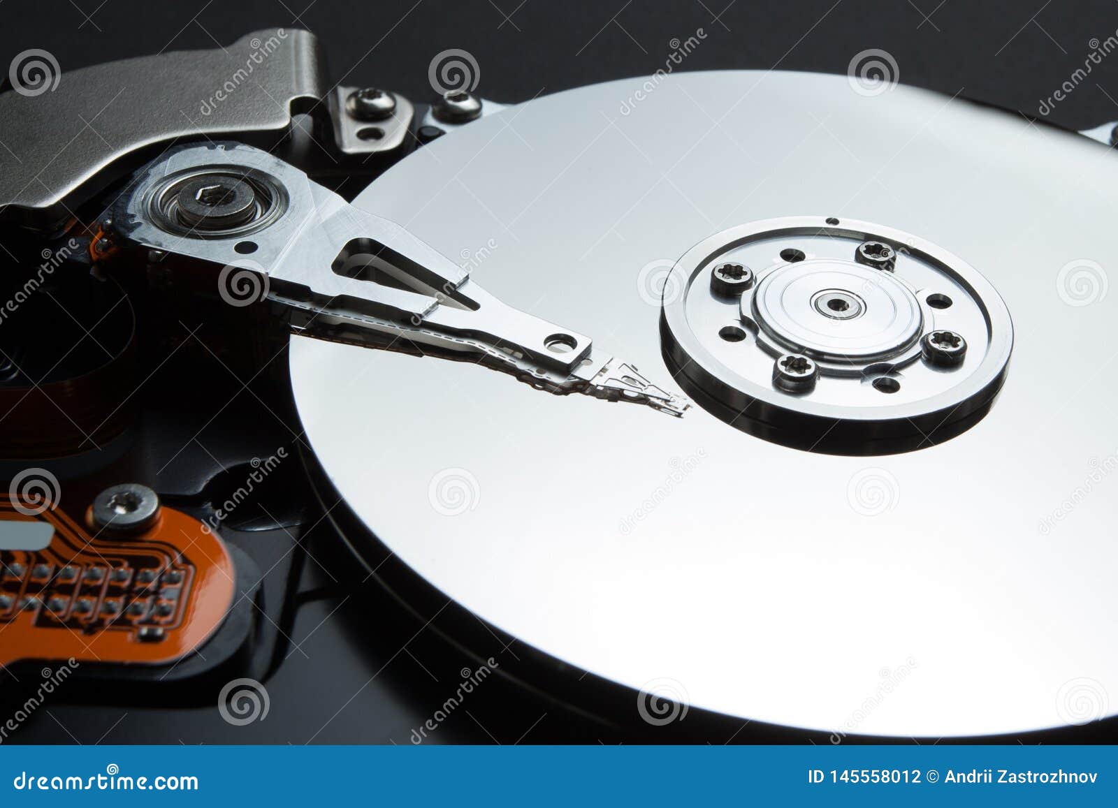 A Close-up of a Magnetic Disk and a Reading Head on a Black Background ...