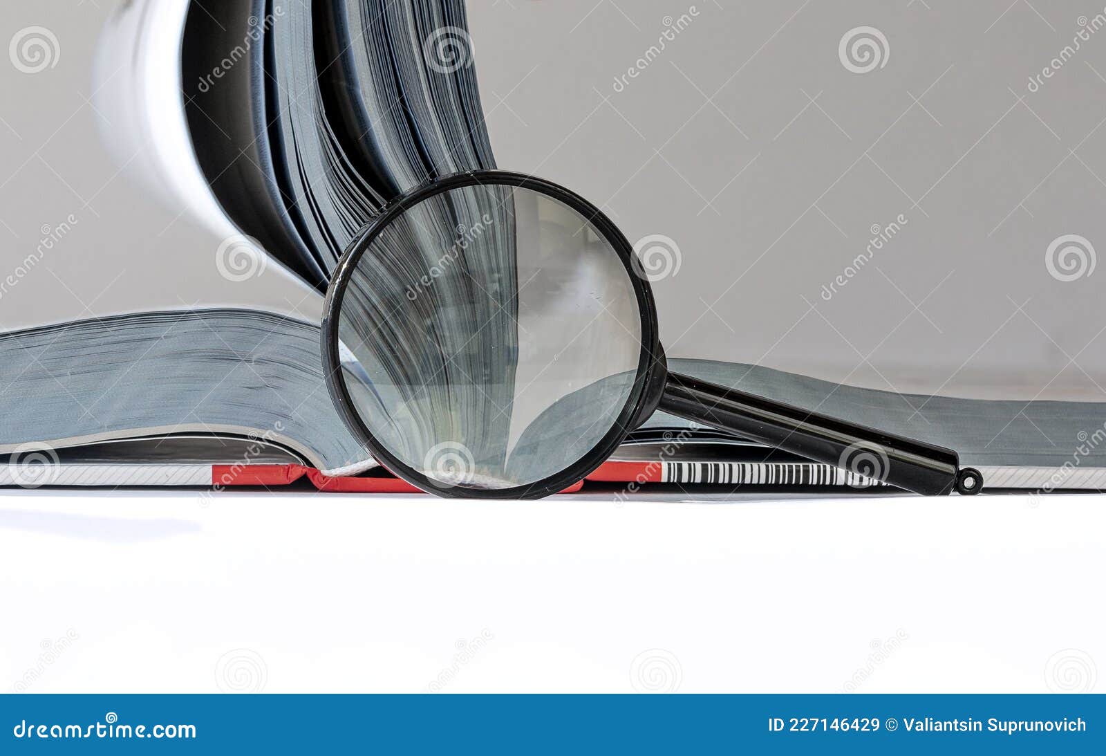 Close Up Magnifying Glass and Technical Book with Turning Pages ...