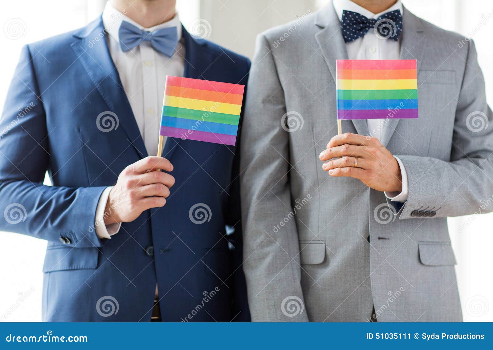 Close Up Of Male Gay Couple Holding Rainbow Flags Stock Image Image