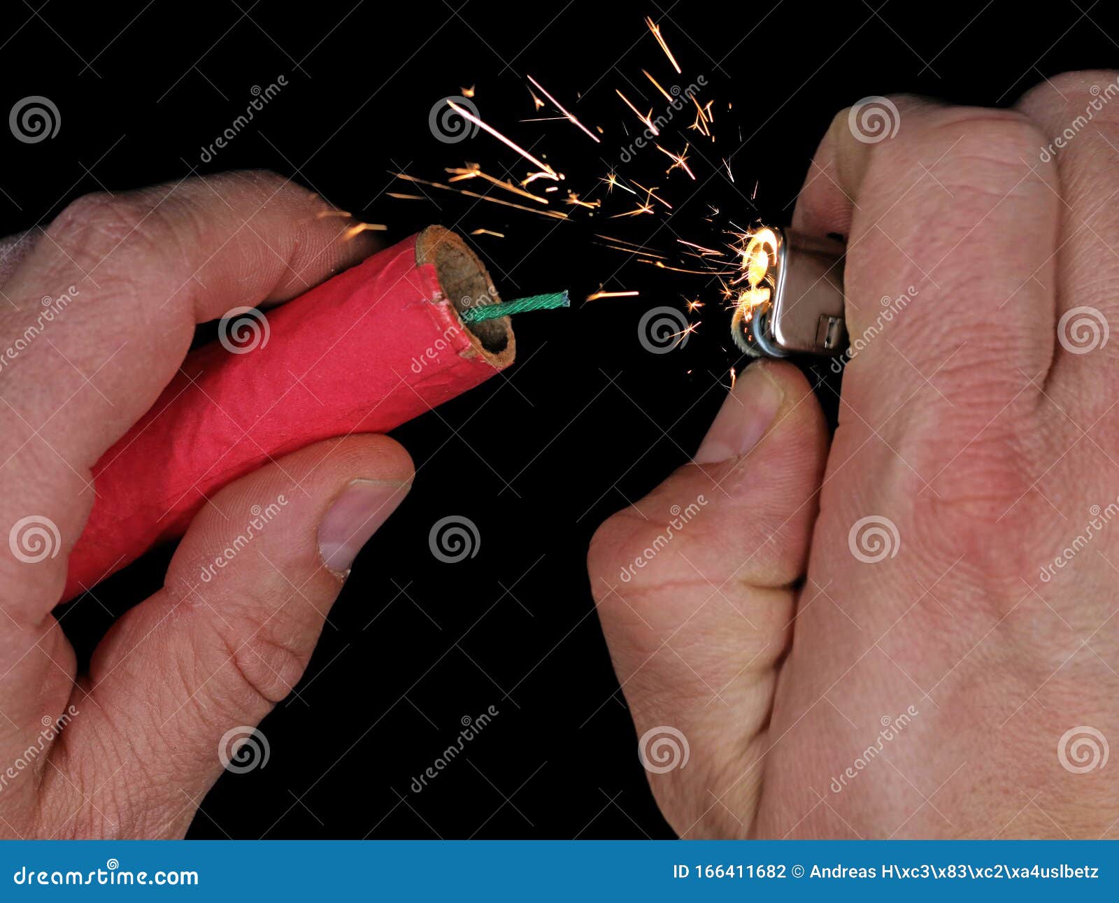 Close Up of Male Hand Lighting Up a Red Firecracker on Black Background ...