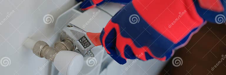 Male Plumber Hands in Gloves Installing or Repairing Heating Radiator ... Male Plumber Hands in Gloves Installing or Repairing Heating Radiator ...