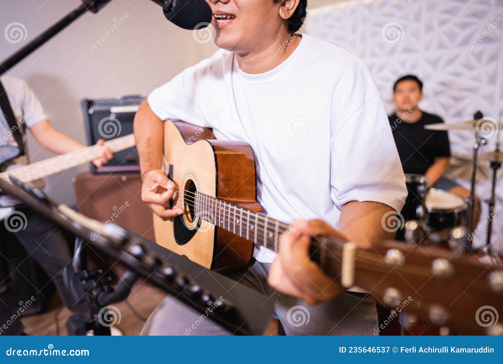 Male Vocalist Singing Into Microphone In Recording Studio. Creating New ... Male Vocalist Singing Into Microphone In Recording Studio. Creating New ...
