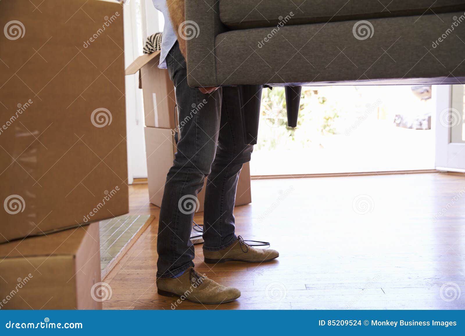 Close Up of Man Carrying Sofa into New Home on Moving Day Stock Photo ...