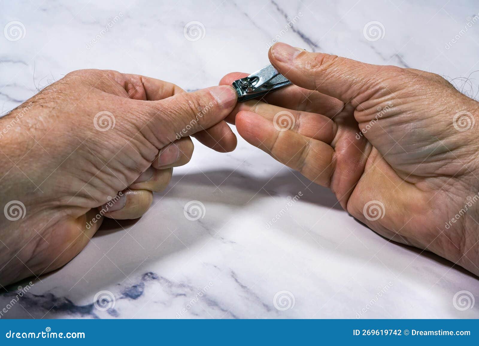 Close Up of Man Cutting Nails Using a Nail Clipper Stock Photo - Image ...