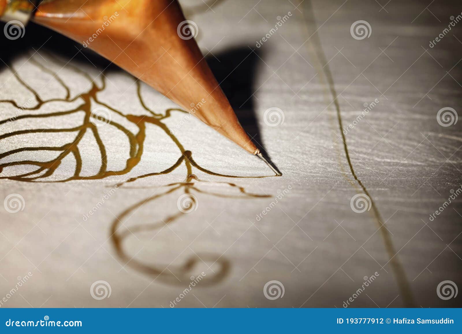 Close-up of Man Drawing Batik Pattern on Fabric, Focus on Tjanting ...