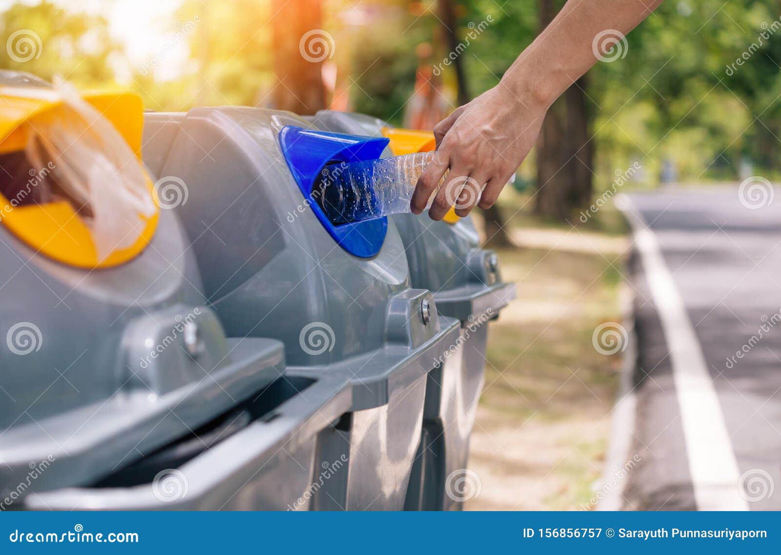 Close Up of Man Hand Throwing a Plastic Bottle into Recycle Dustbin ...