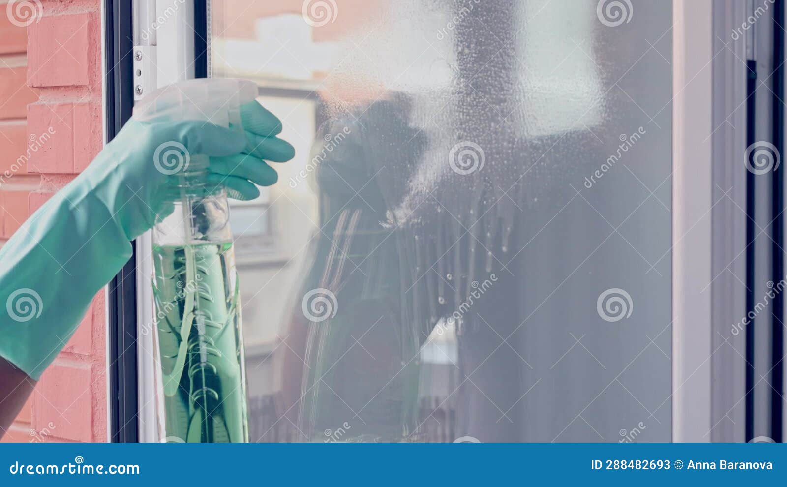Close Up Man Hands With Rubber Gloves Cleaning A Window Using Sprayed
